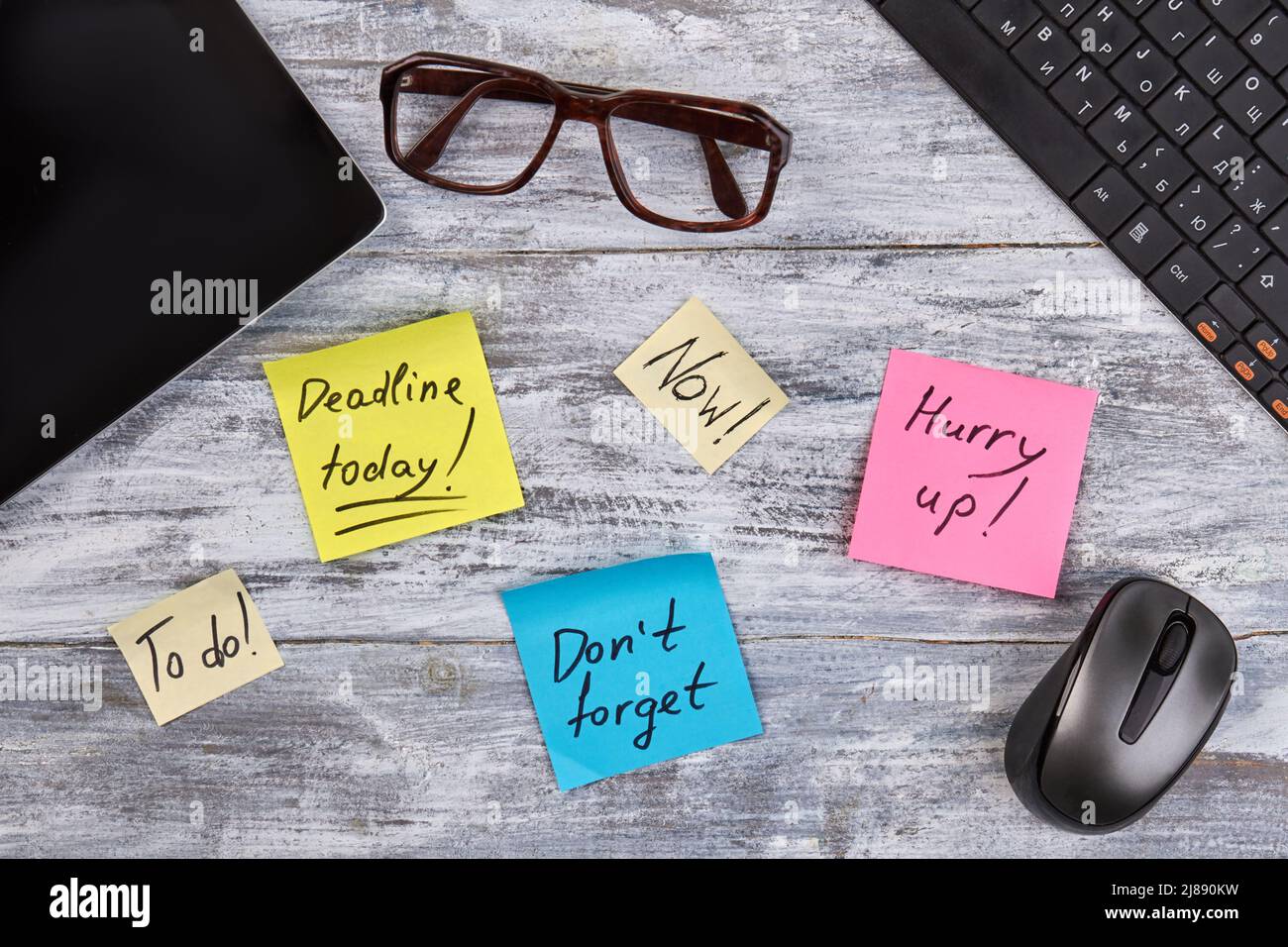 Top view sticky notes with glasses and mouse. Gray desk background ...