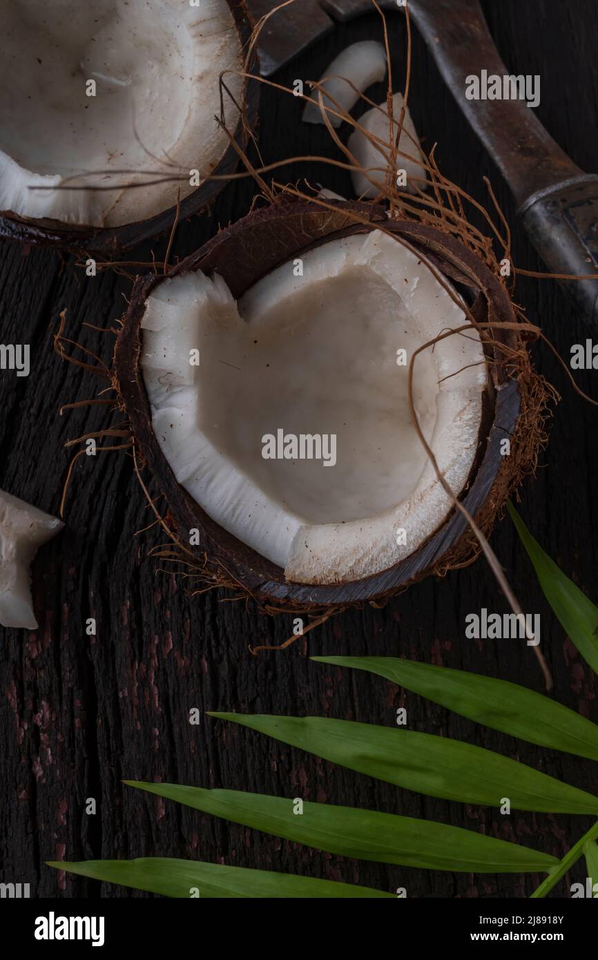Chopped coconut on a wooden background, top view. Coconut milk and ...