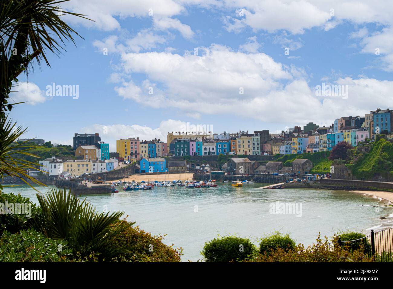 Tenby Beach on a sunny day North beach iconic colourful houses Stock ...