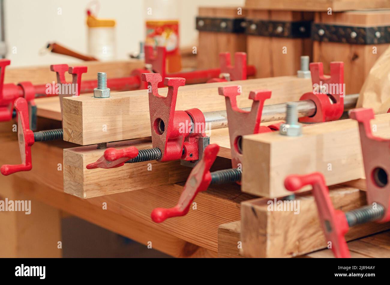 Close up of carpenter fastening board with clamps. Carpentry workshop ...