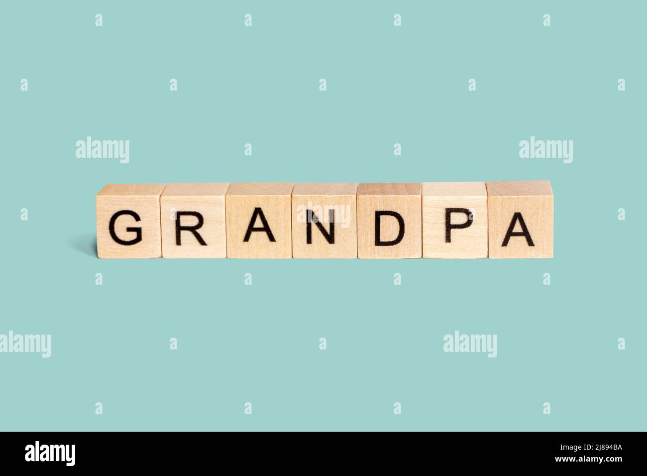 Wooden cubes with the word Grandpa on pastel blue background with copy ...