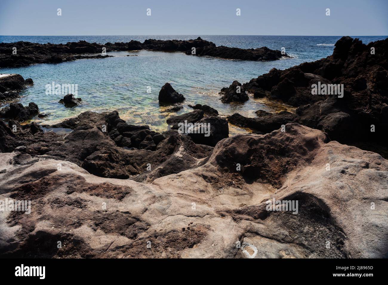 View of the scenic lava rock cliff in the Linosa island. Sicily Stock ...
