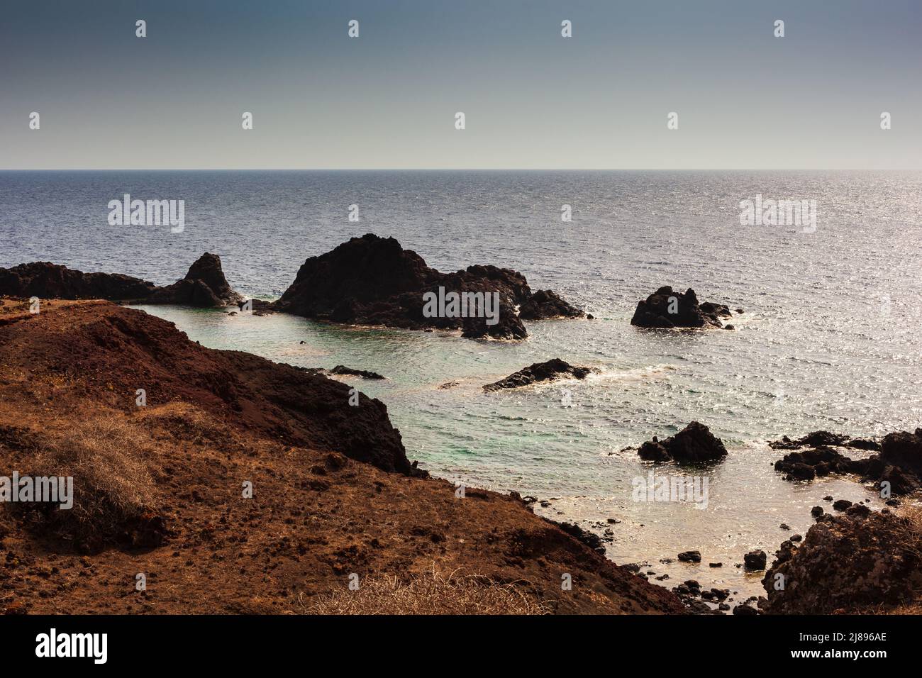 View of the scenic lava rock cliff in the Linosa island. Sicily Stock ...