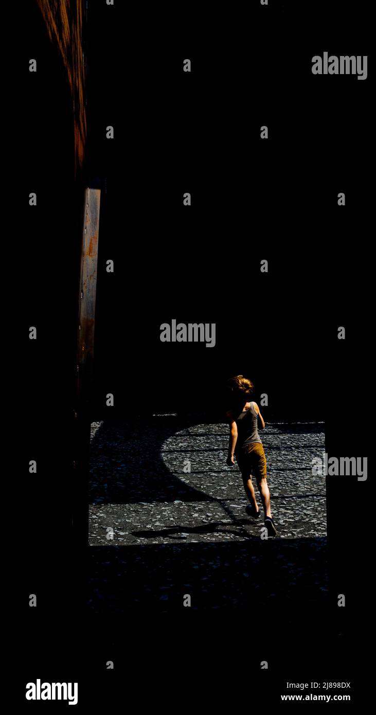 Kid running in a maze Stock Photo - Alamy