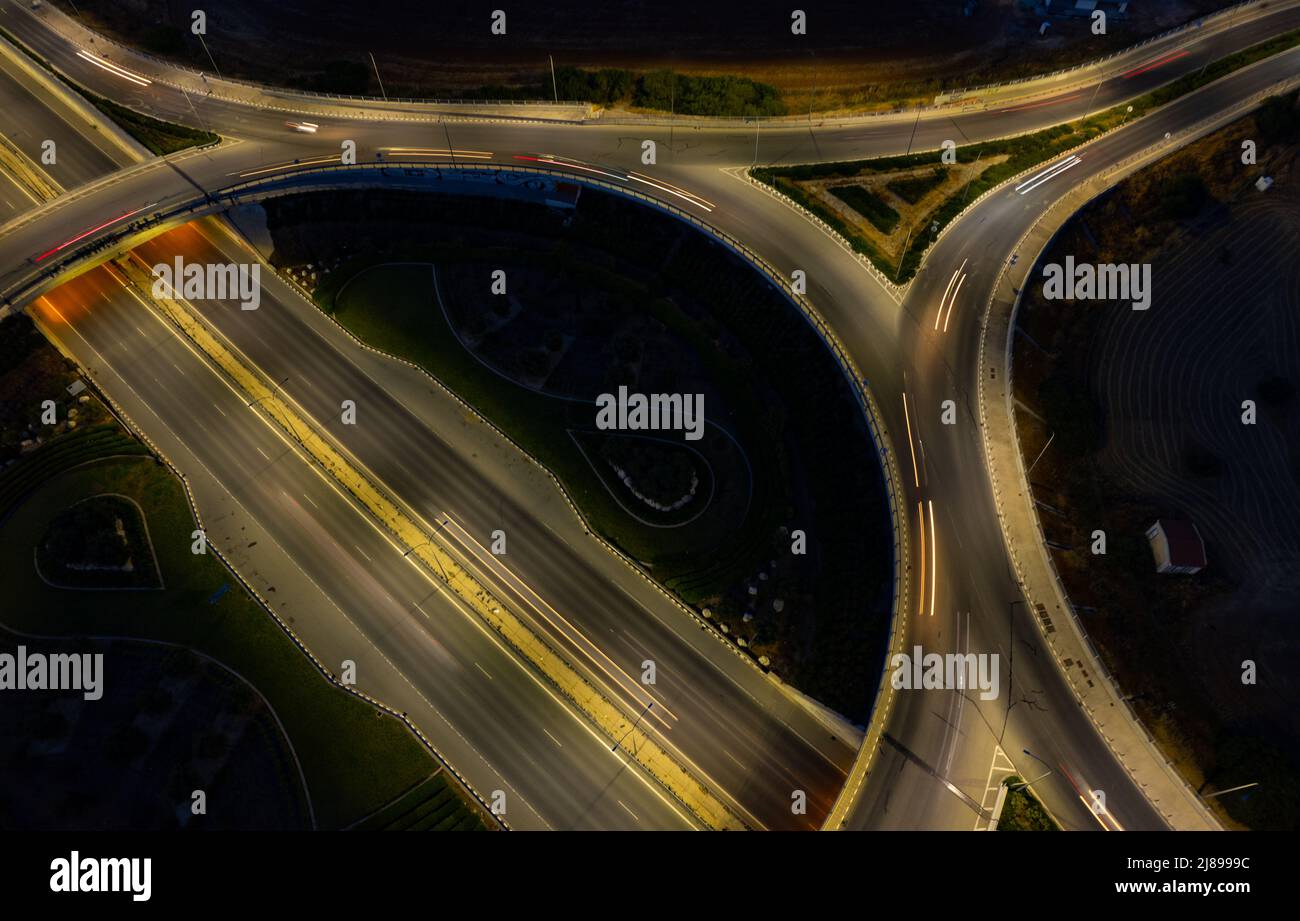 Aerial drone view of highway junction. Roundabout cars moving fast ...