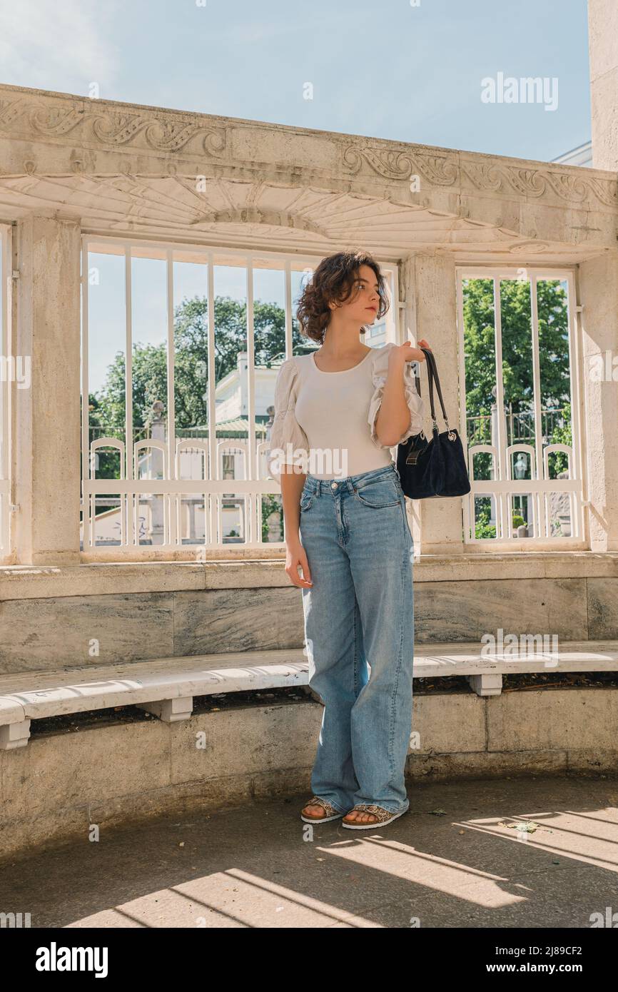 Portrait of carefree teenage girl posing for camera, squinting eyes ...