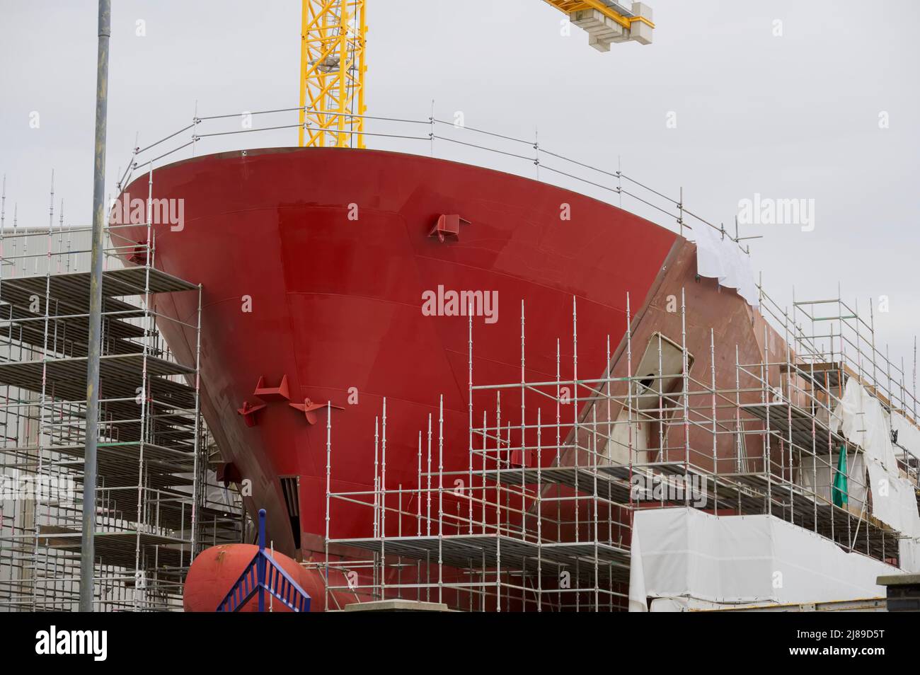 Shipbuilding and crane during ferry construction surrounded by scaffold ...