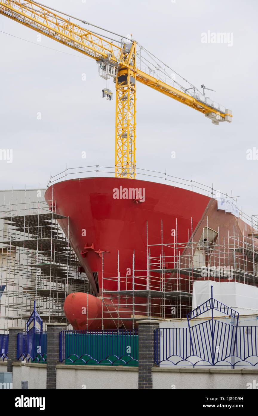 Shipbuilding and crane during ferry construction surrounded by scaffold ...