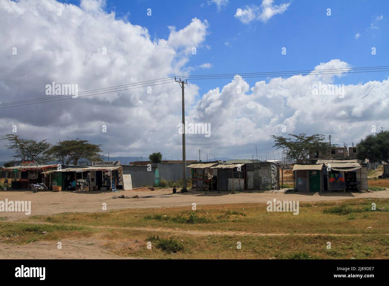 Small shops in wooden shacks at side of road. in Kenyan village ...
