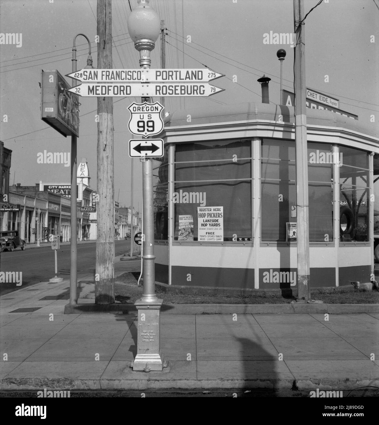 Sign of service station, U.S. 99. Hop pickers are wanted for four big ...