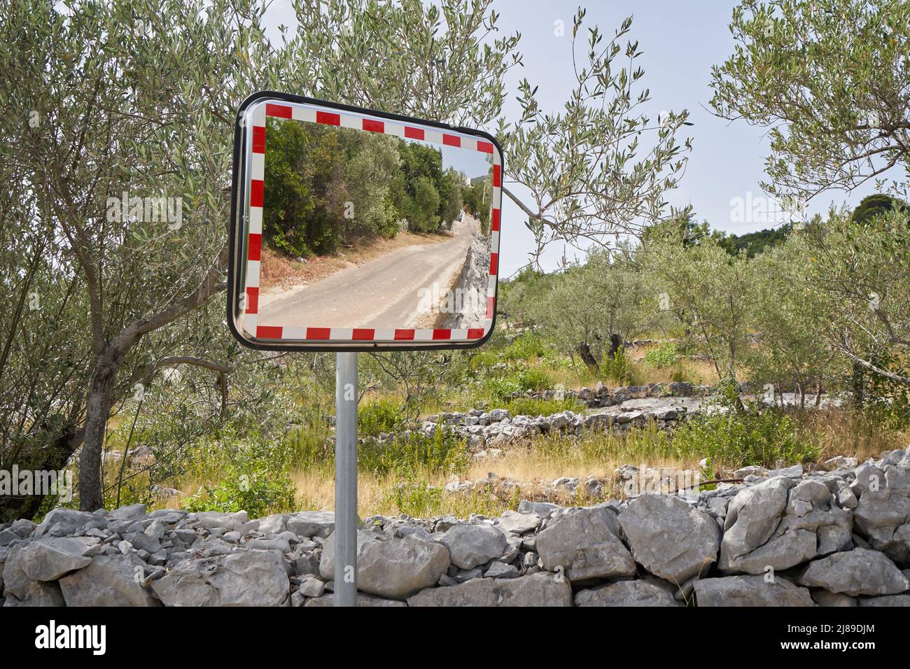 Road mirror for safe driving on the country road Stock Photo - Alamy