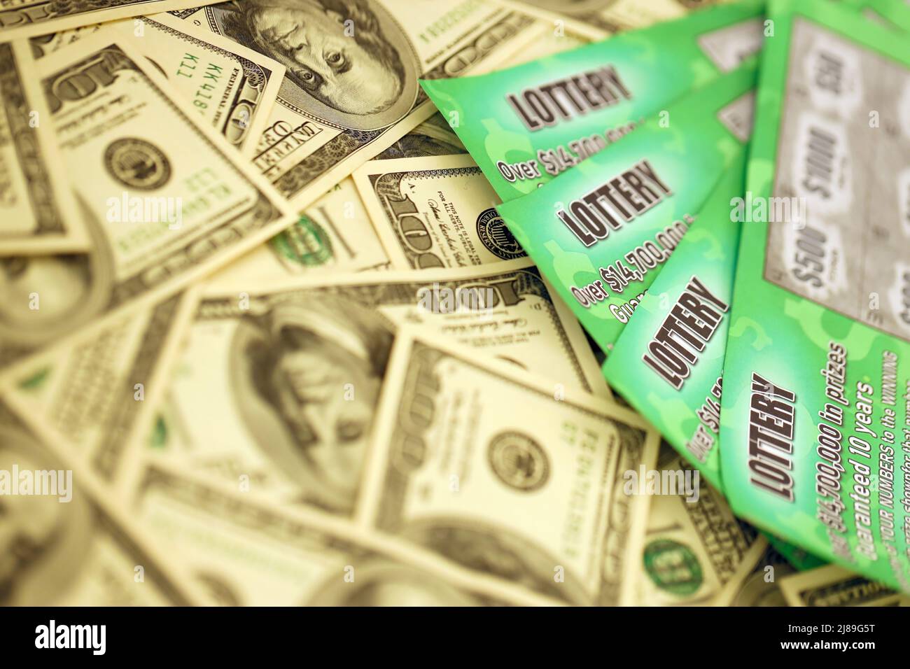 Close up view of green lottery scratch cards and us dollar bills. Many ...