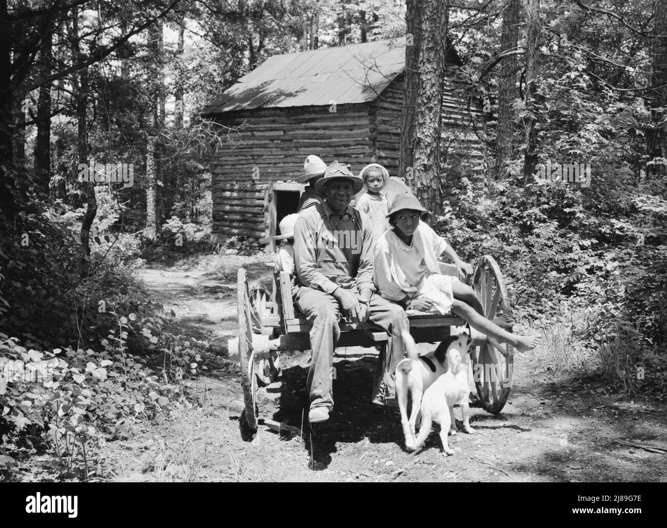 Colored sharecropper and his children about to leave home through the ...