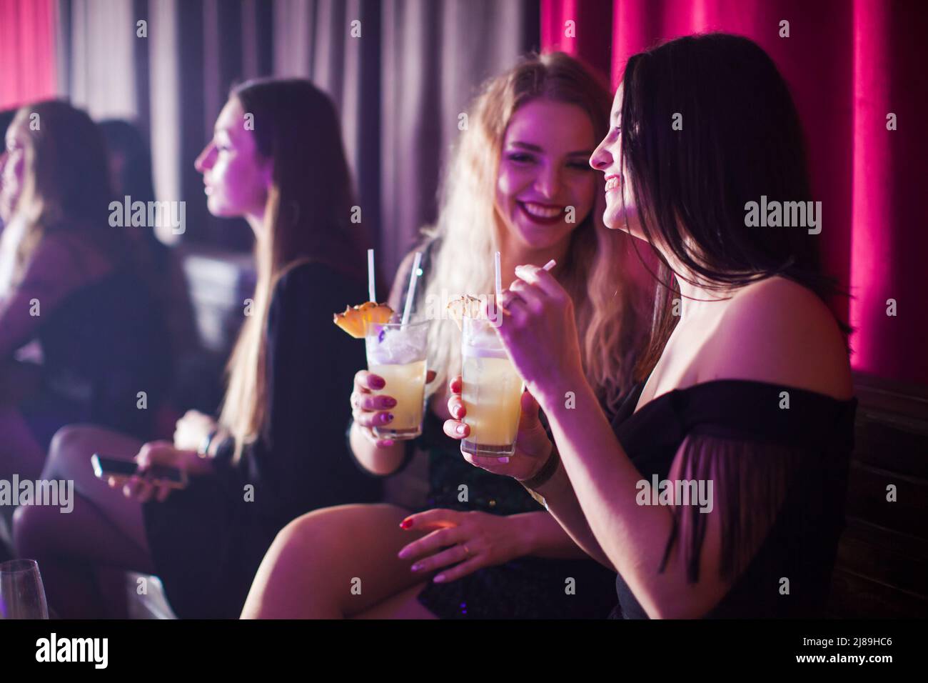 Women have fun and drinking cocktails with fruits Stock Photo - Alamy