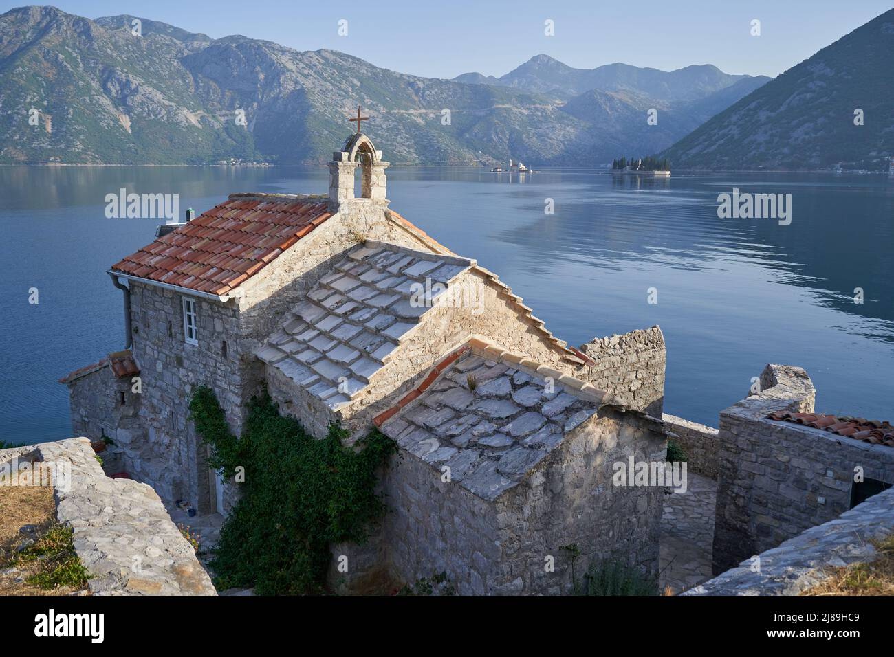 Stone church Our Lady of Angels by the sea with a view of the mountains ...