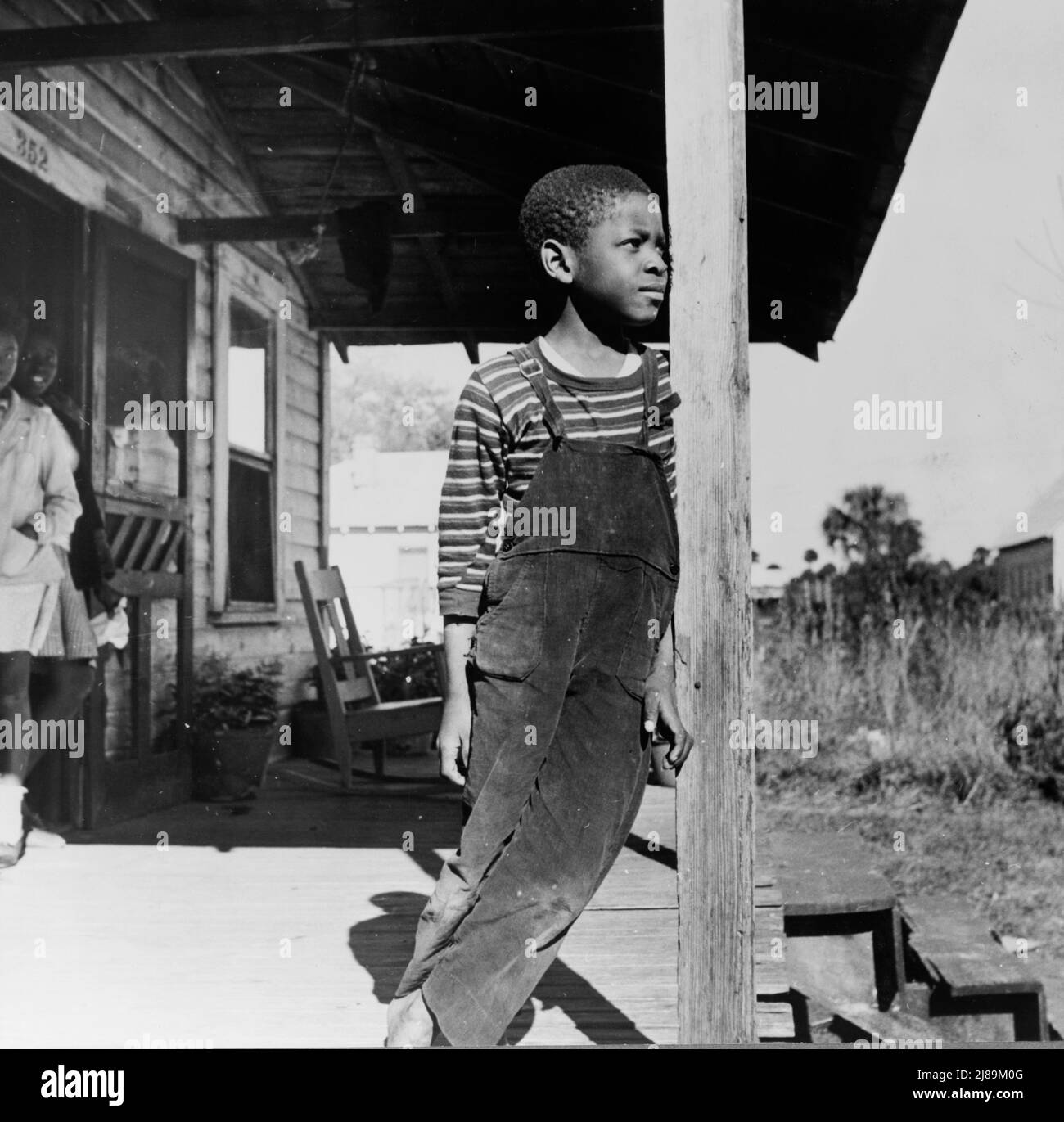 Daytona Beach, Florida. Young boy on his front porch Stock Photo - Alamy