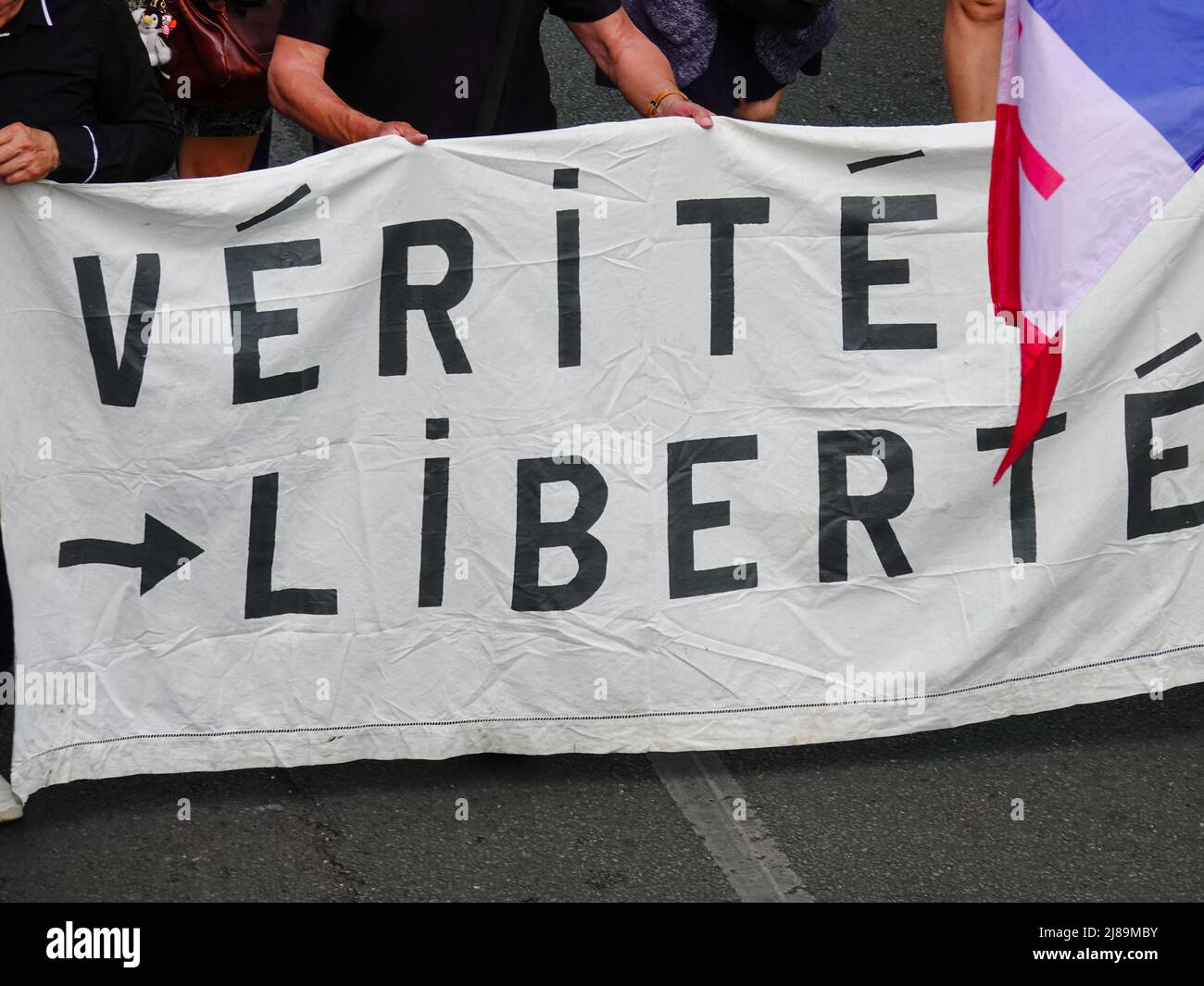 Paris France 14 May 2022. Small group of protestors marching down blvd ...