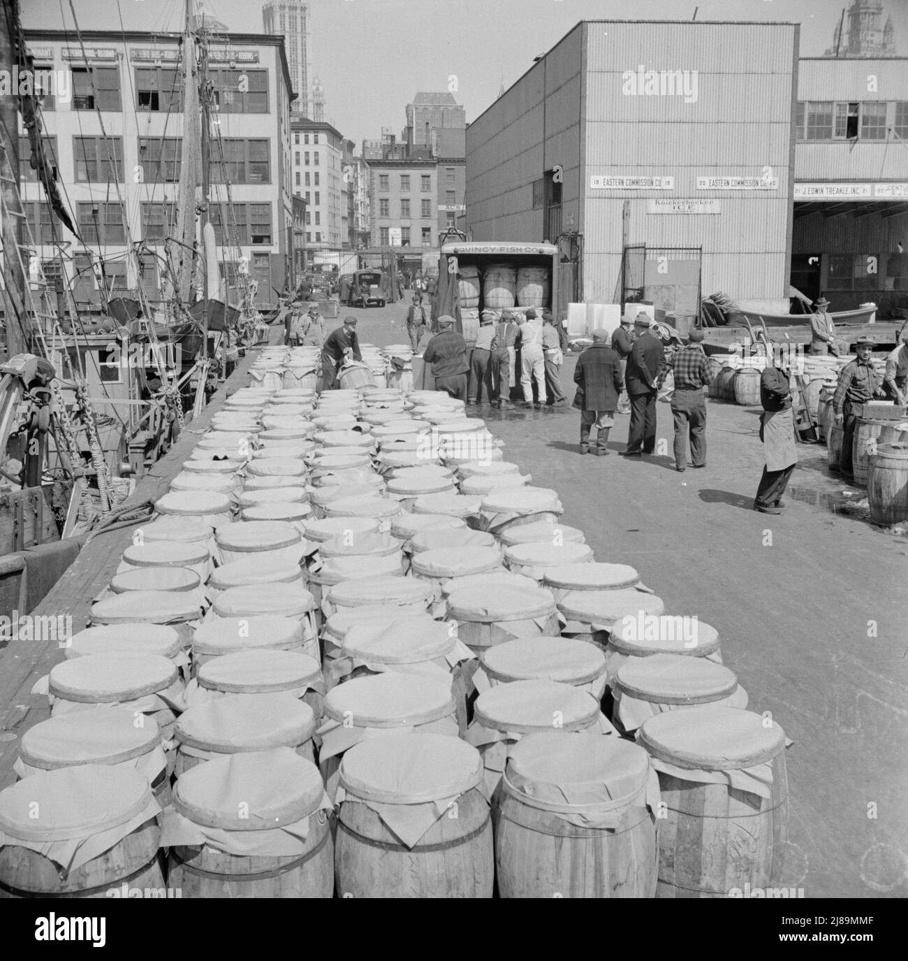 New York, New York. Barrels of fish on the docks at Fulton fish market ...