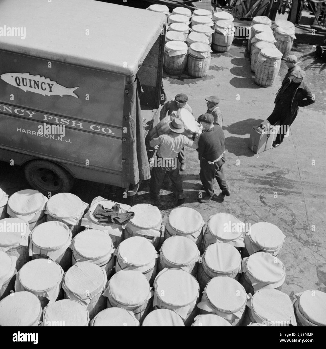 New York, New York. Barrels of fish on the docks at Fulton fish market ...