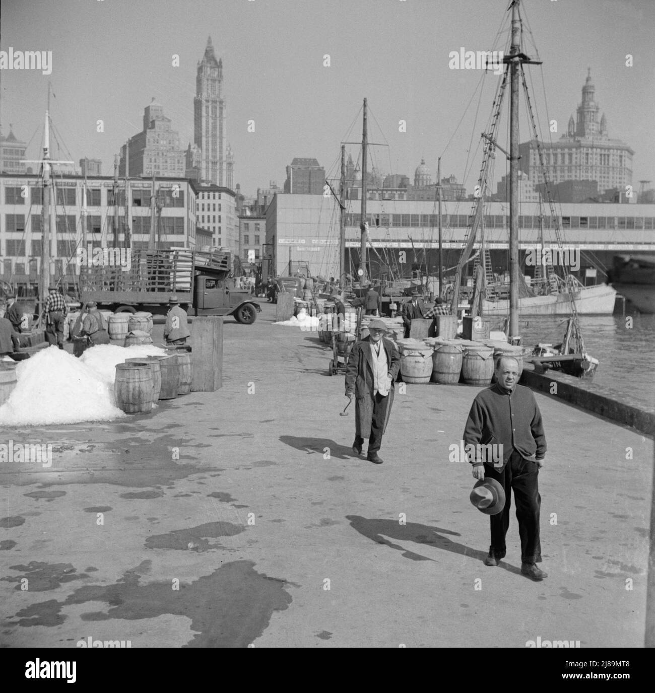 New York, New York. Barrels of fish on the docks at Fulton fish market ...