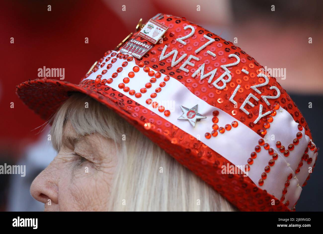 London, England, 14th May 2022. A Liverpool fan wears a hat showing the ...