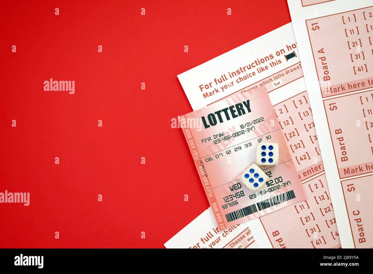 Red lottery ticket with dice lies on pink gambling sheets with numbers ...
