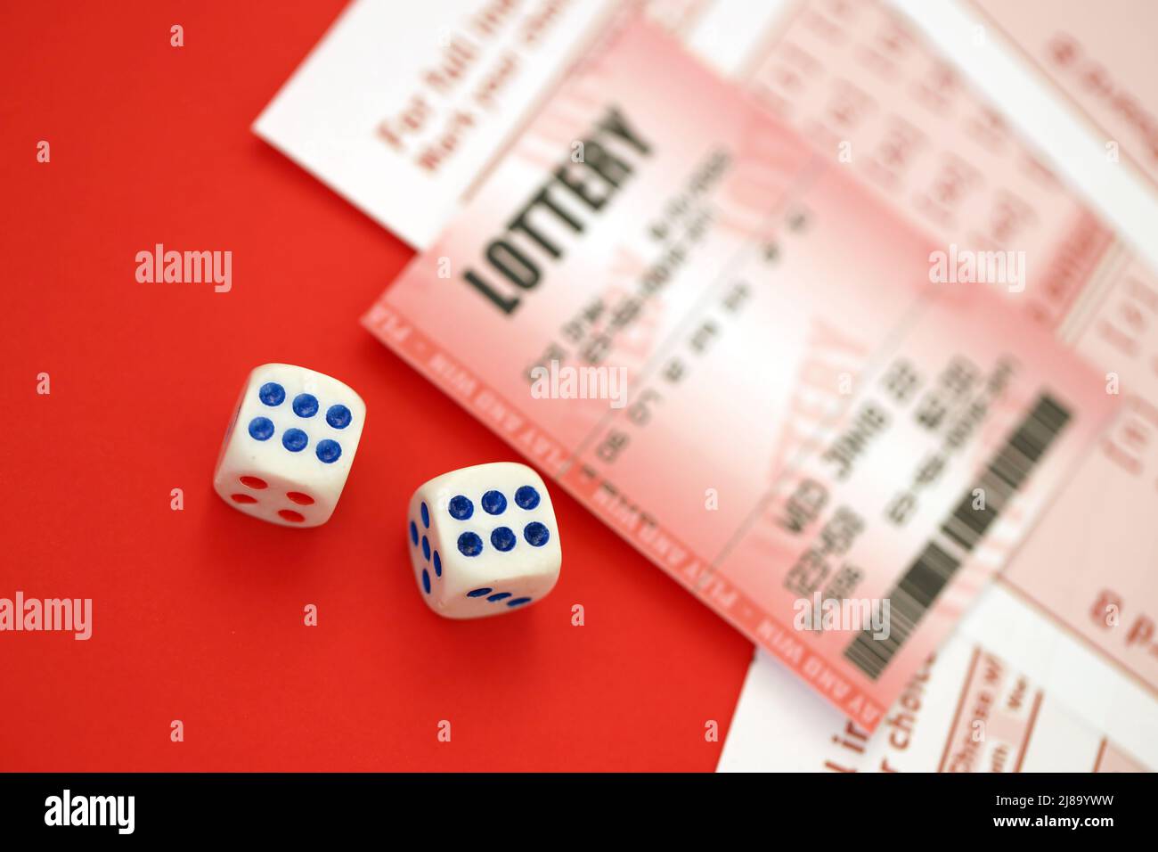 Red lottery ticket with dice lies on pink gambling sheets with numbers ...