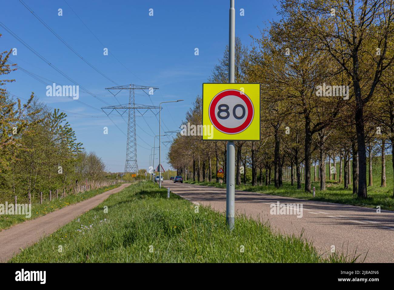 Traffic sign: maximum speed 80 between a rural road and a bicycle lane ...