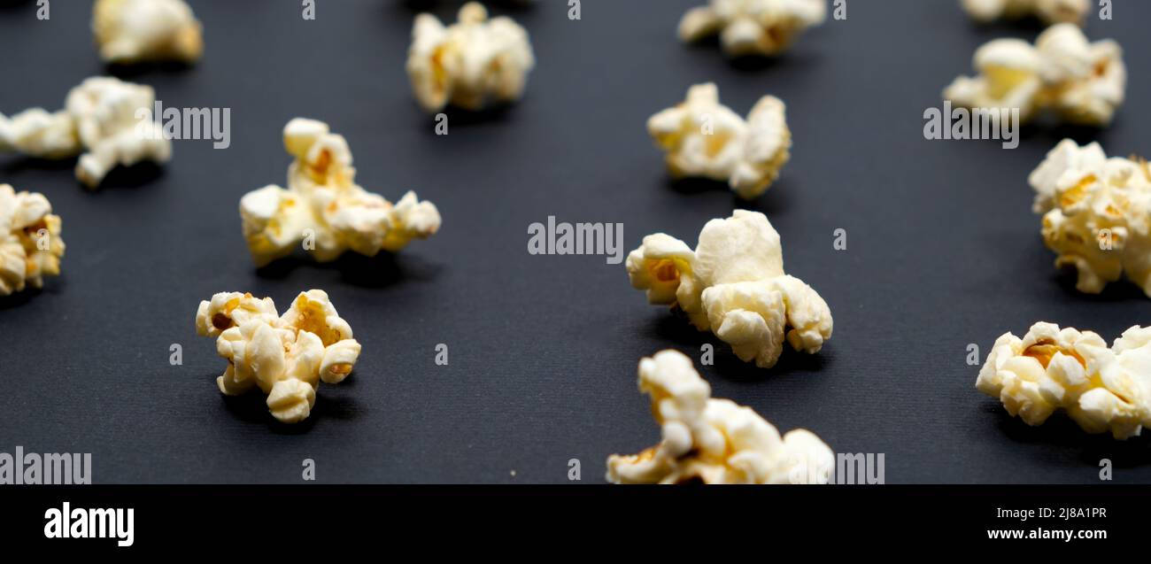 Popcorn on an black background, close-up, long banner Stock Photo - Alamy