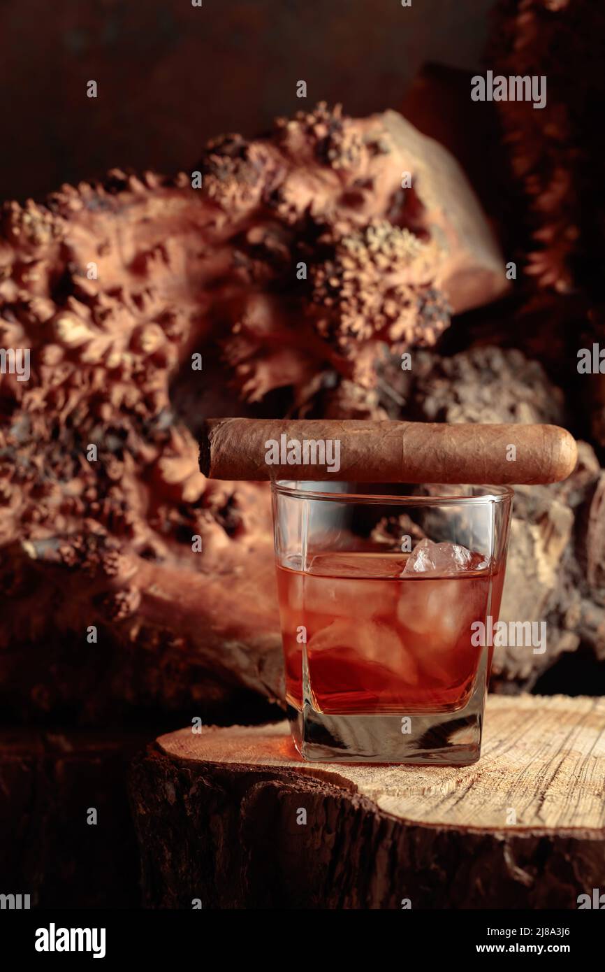 Whiskey wit ice and cigar on an old dried stump. Copy space Stock Photo ...