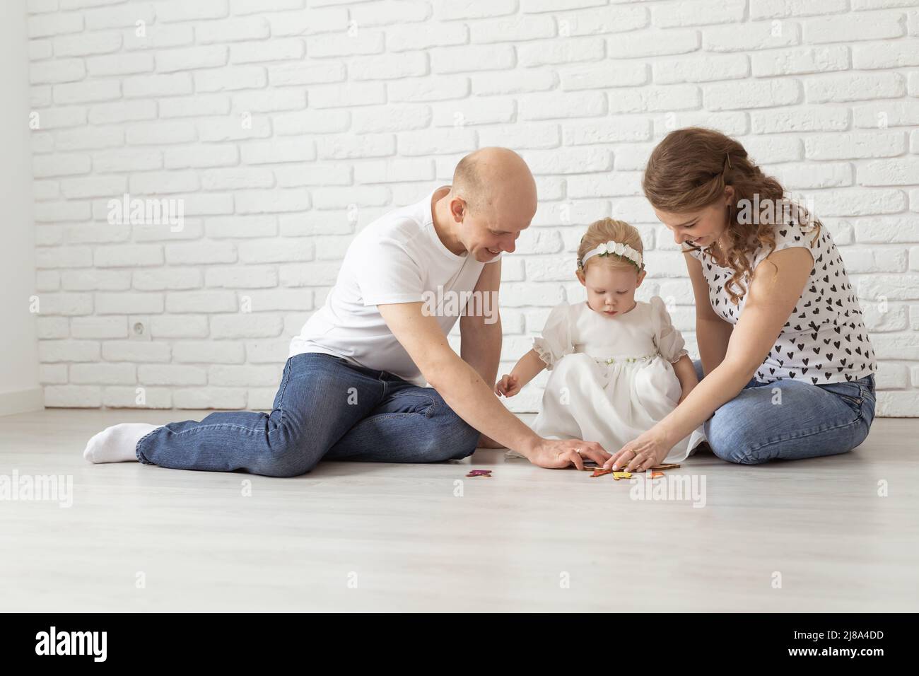 Baby child with hearing aids and cochlear implants plays with parents ...