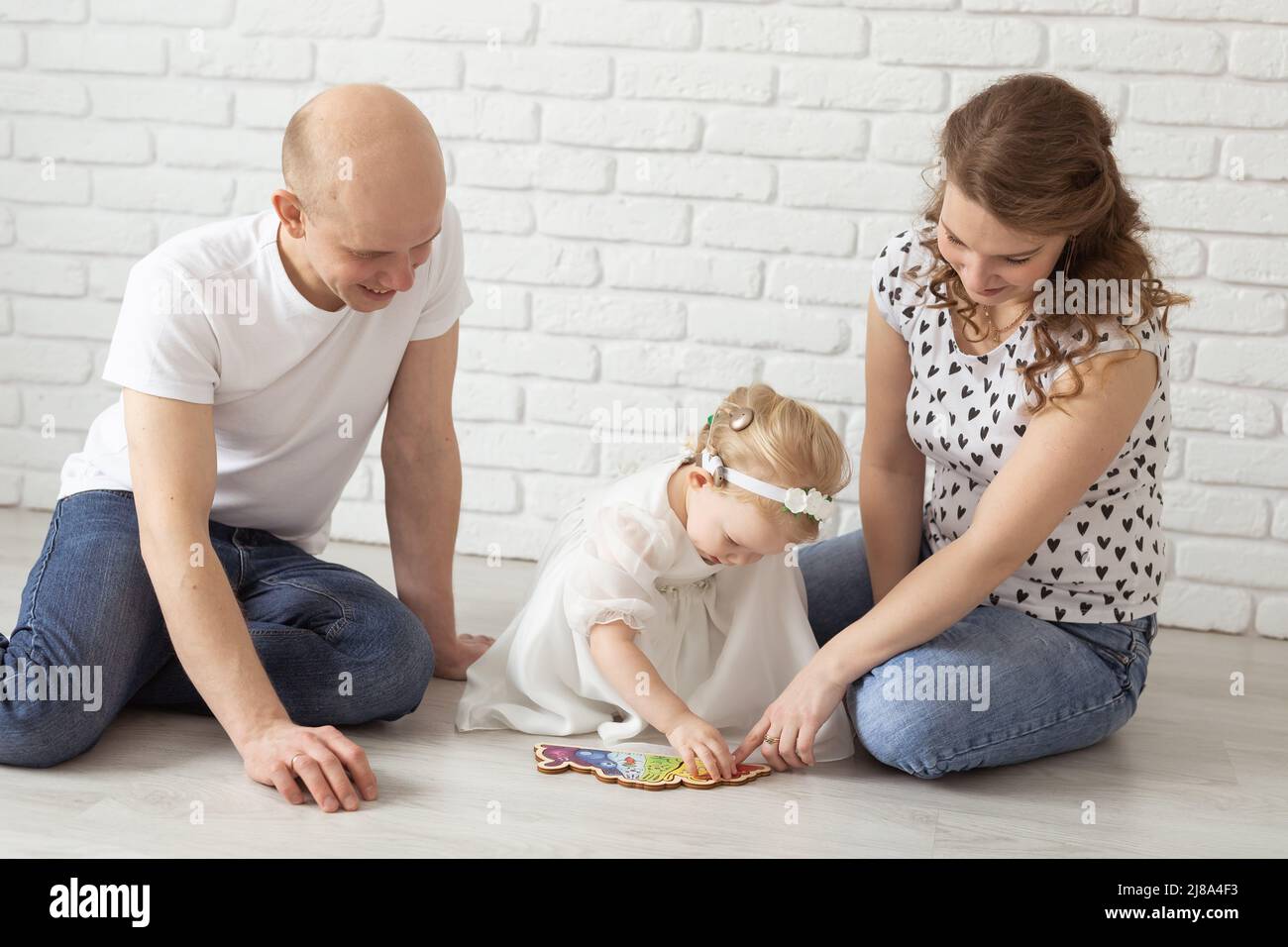 Baby child with hearing aids and cochlear implants plays with parents ...
