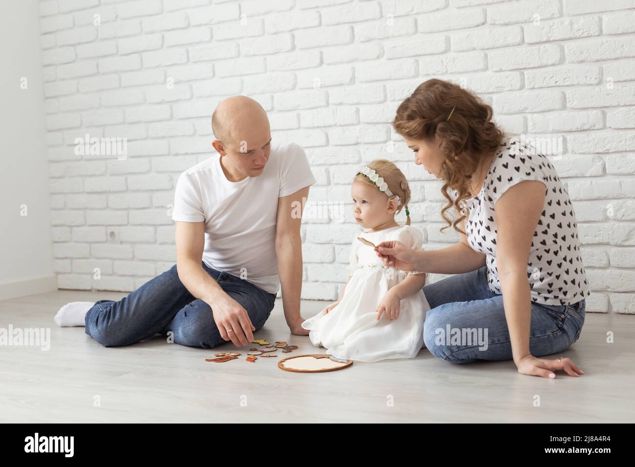 Baby child with hearing aids and cochlear implants plays with parents ...