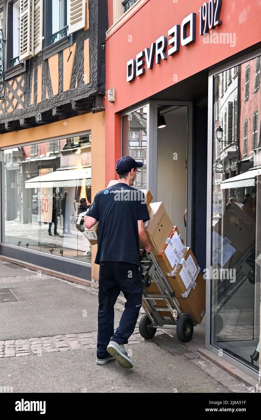 Colmar, France - April 2022: Person wheeling a trolley full of boxes ...