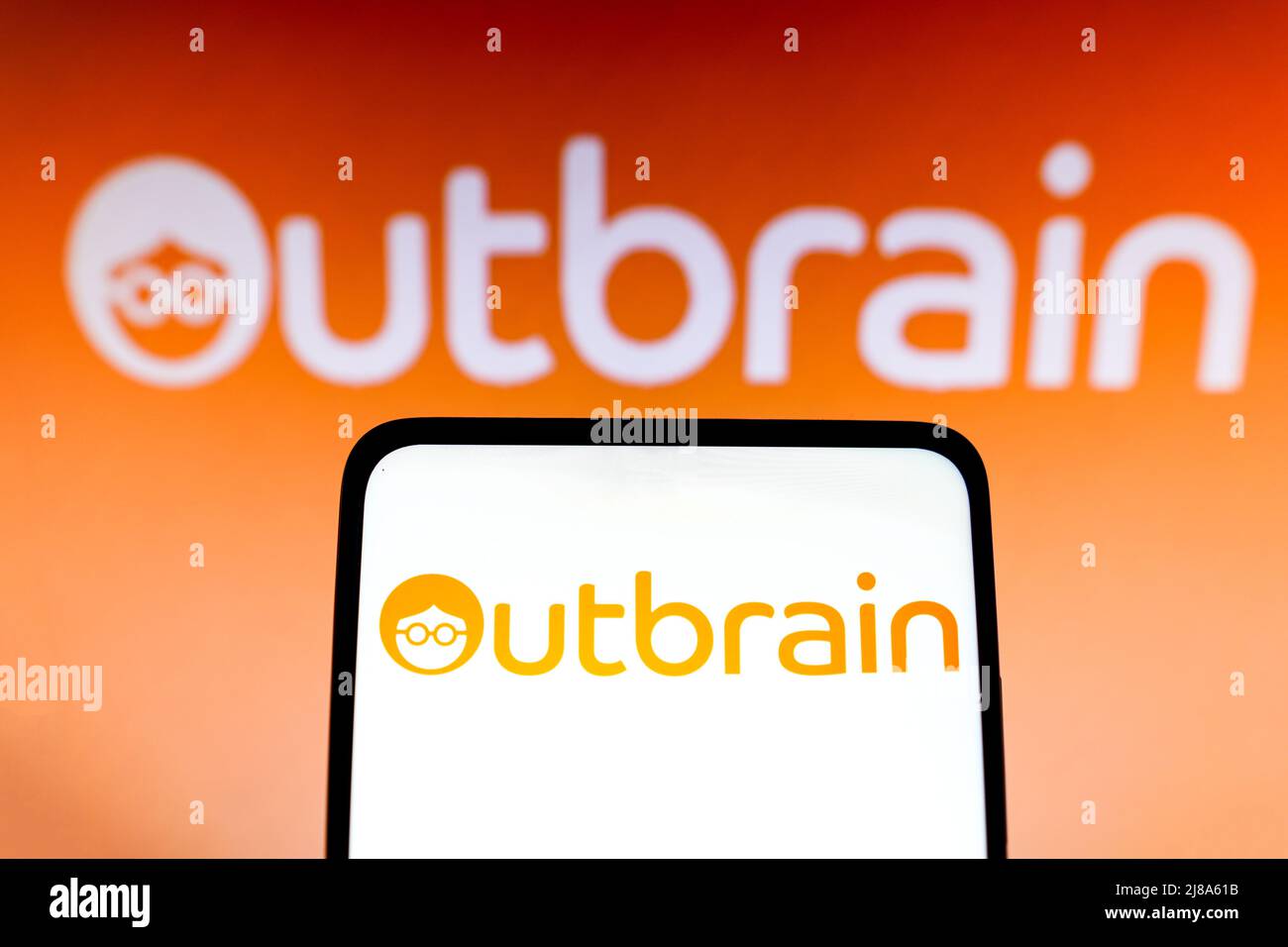In this photo illustration the Outbrain logo seen displayed on a ...