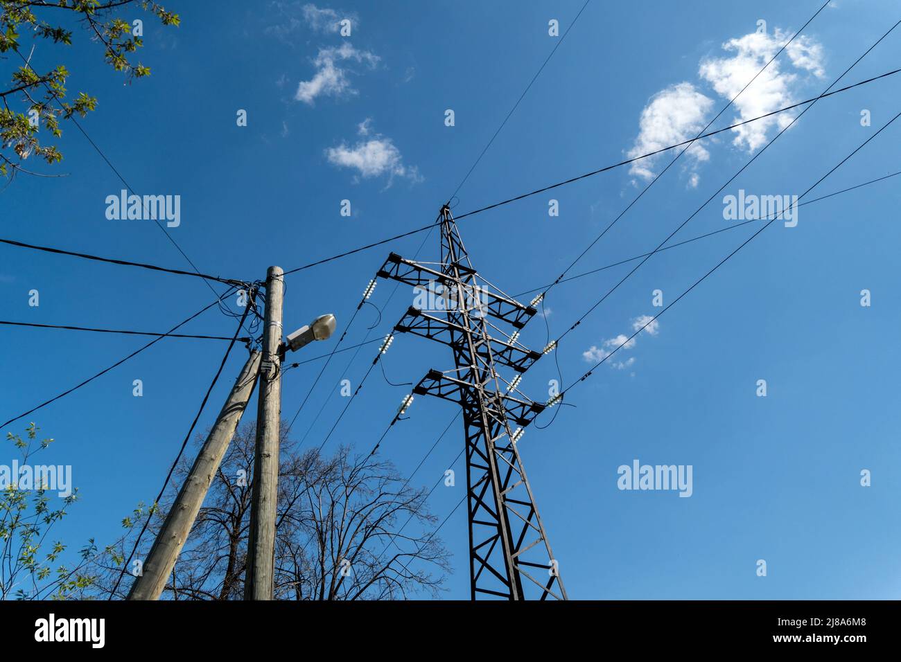 High voltage grid tower with wire cable at distribution station. energy ...
