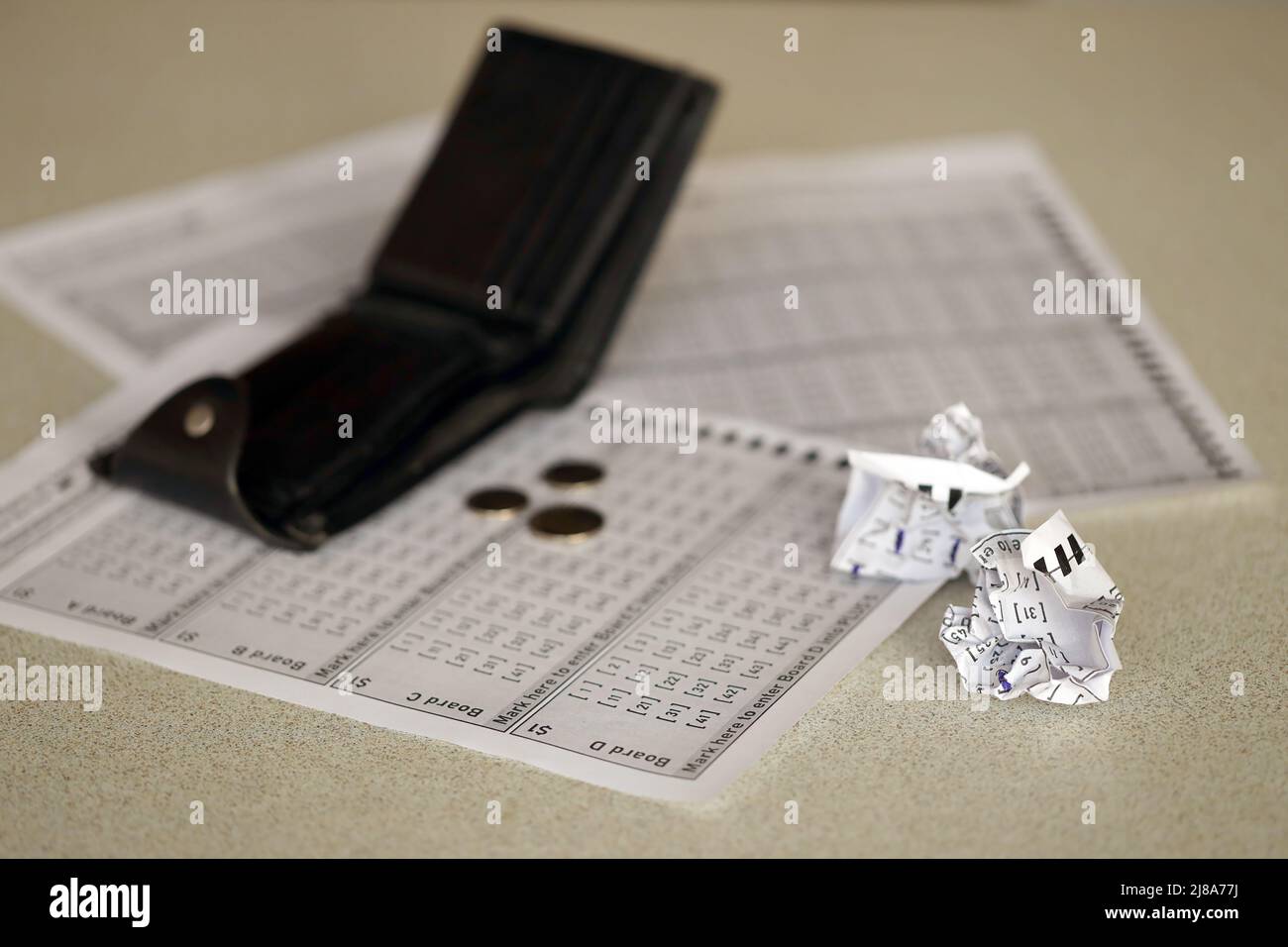 Crumpled lottery tickets and empty purse as symbol of losing the ...