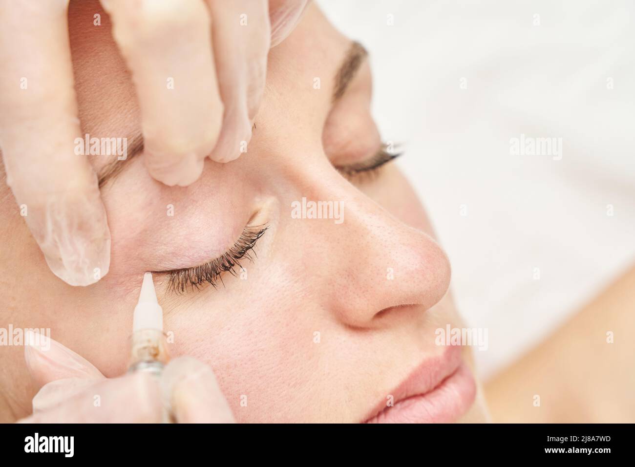 Permanent makeup. Beauty spa procedure. young woman. Face tattoo. Eye ...