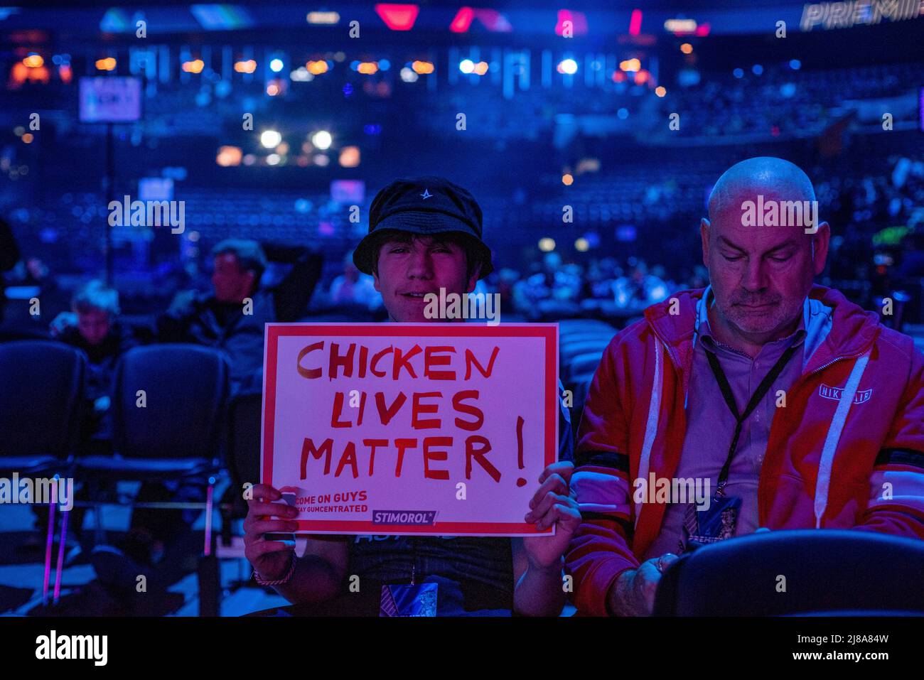 a kid holding up a sign saying "chicken lives matter" a reference to a ...