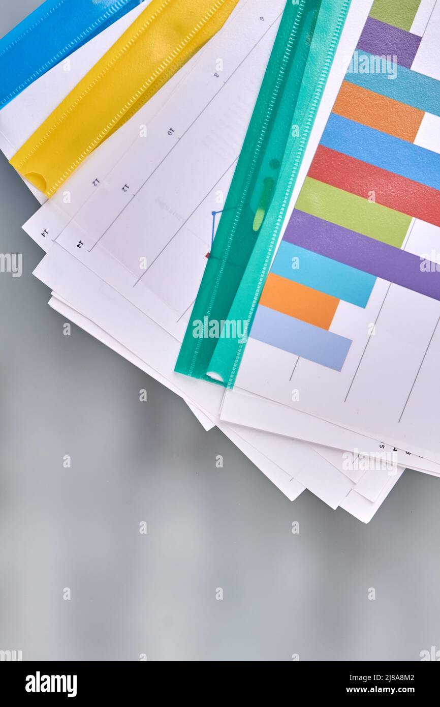 Vertical shot folders with work papers on blurred background. Top view ...