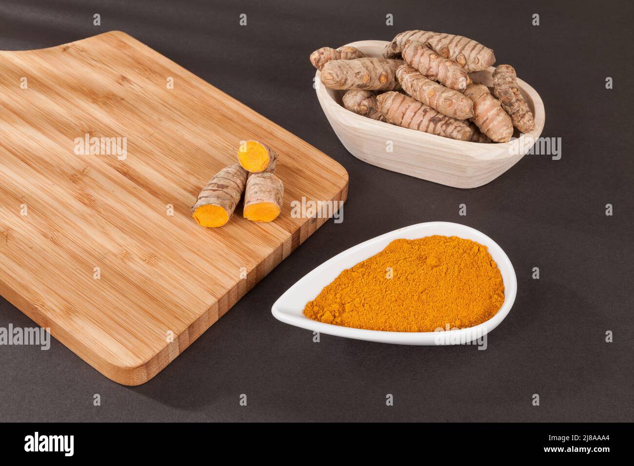 Turmeric - Curcuma longa root and turmeric powder; Photo on dark ...
