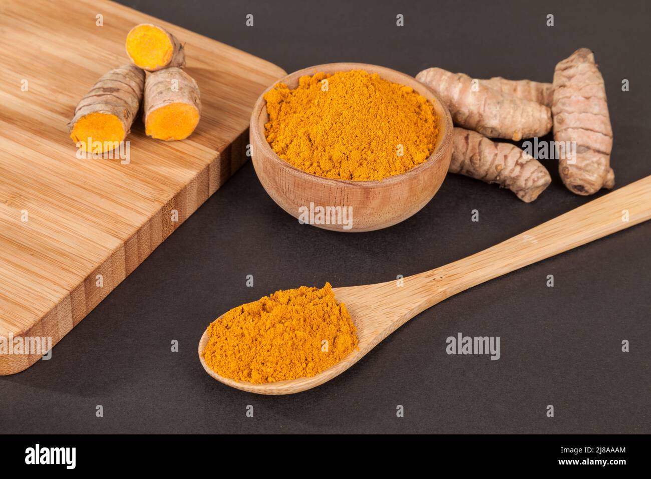 Turmeric - Curcuma longa root and turmeric powder; Photo on dark ...