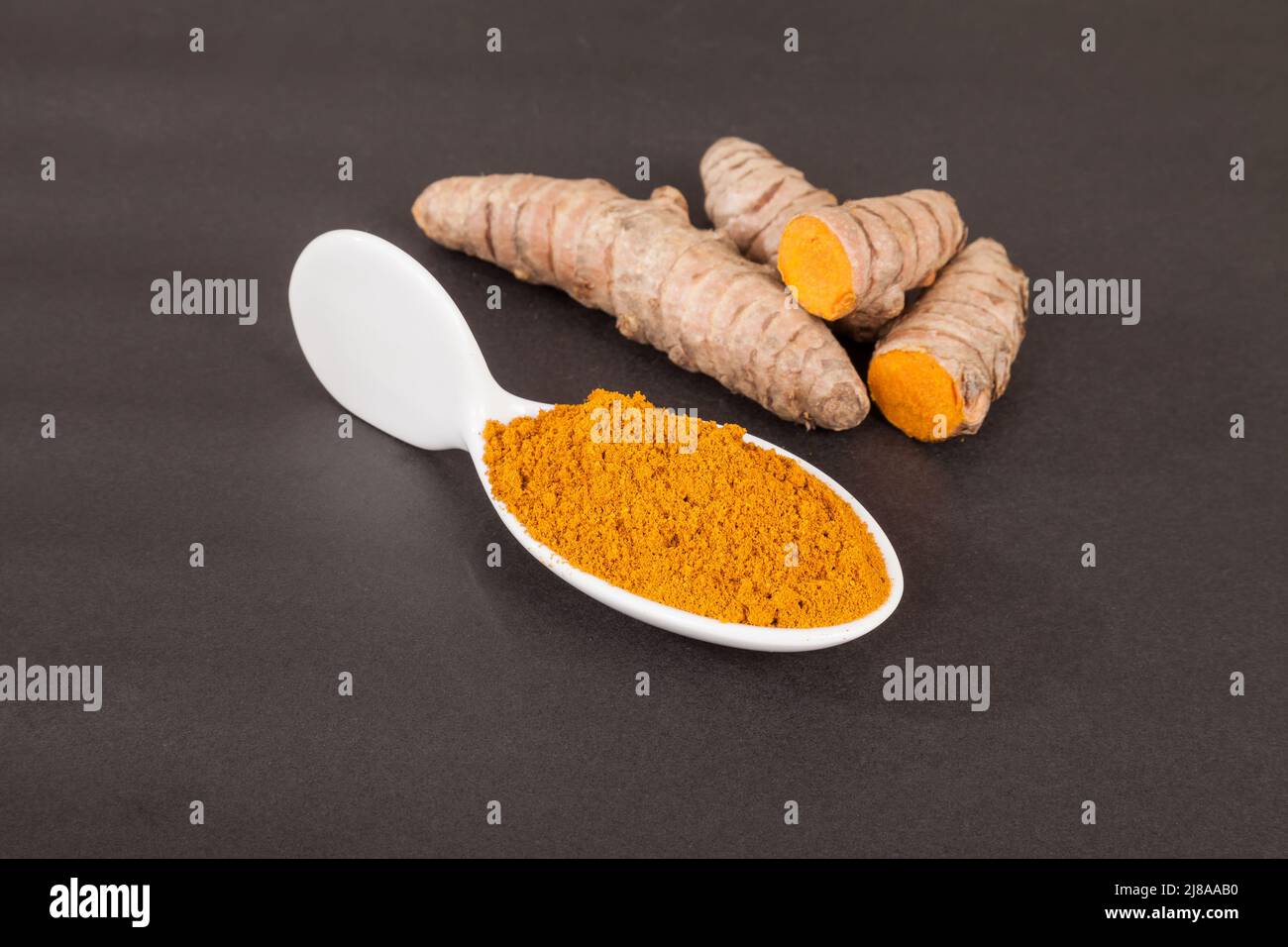 Turmeric - Curcuma longa root and turmeric powder; Photo on dark ...