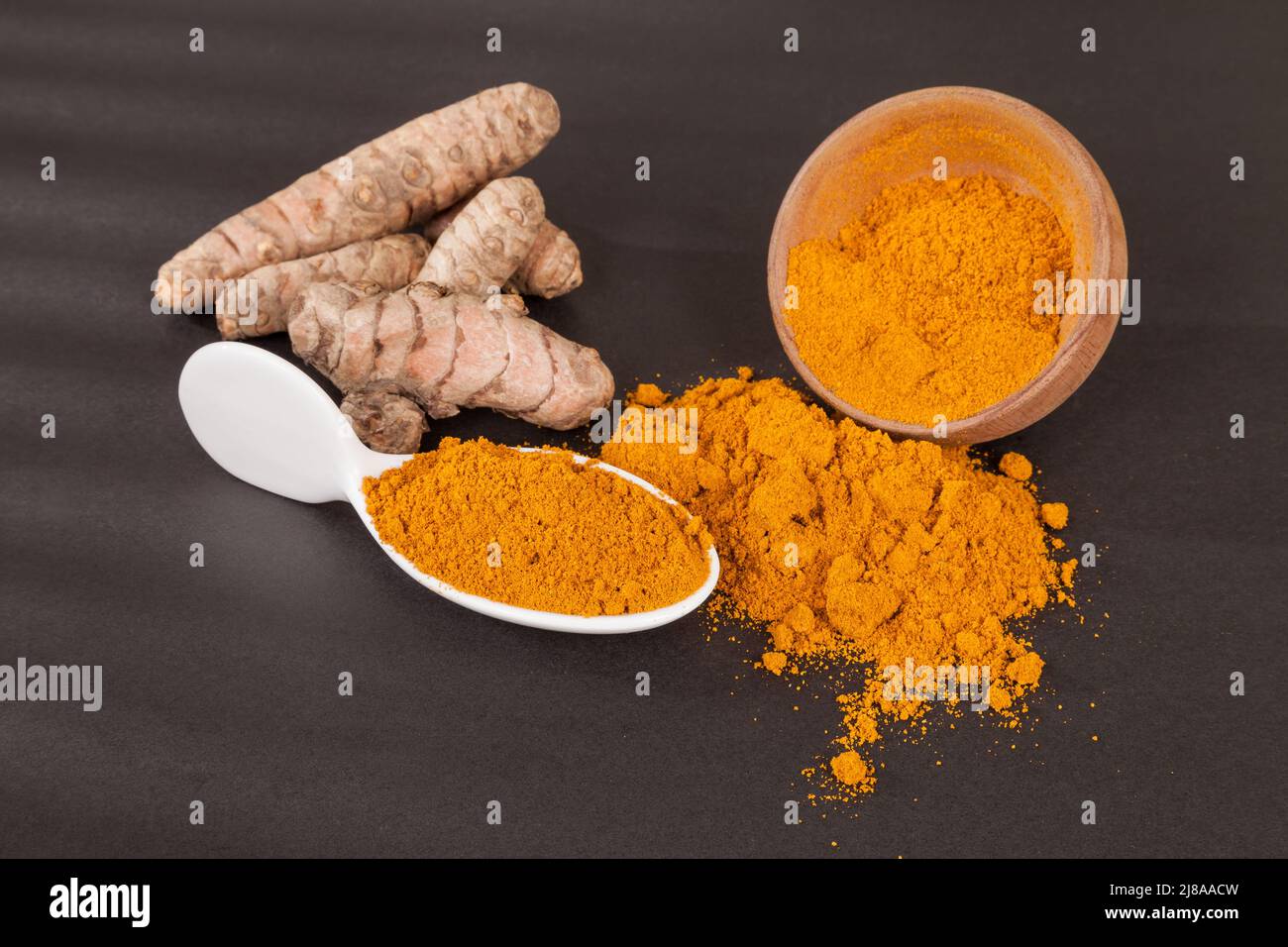 Turmeric - Curcuma longa root and turmeric powder; Photo on dark ...