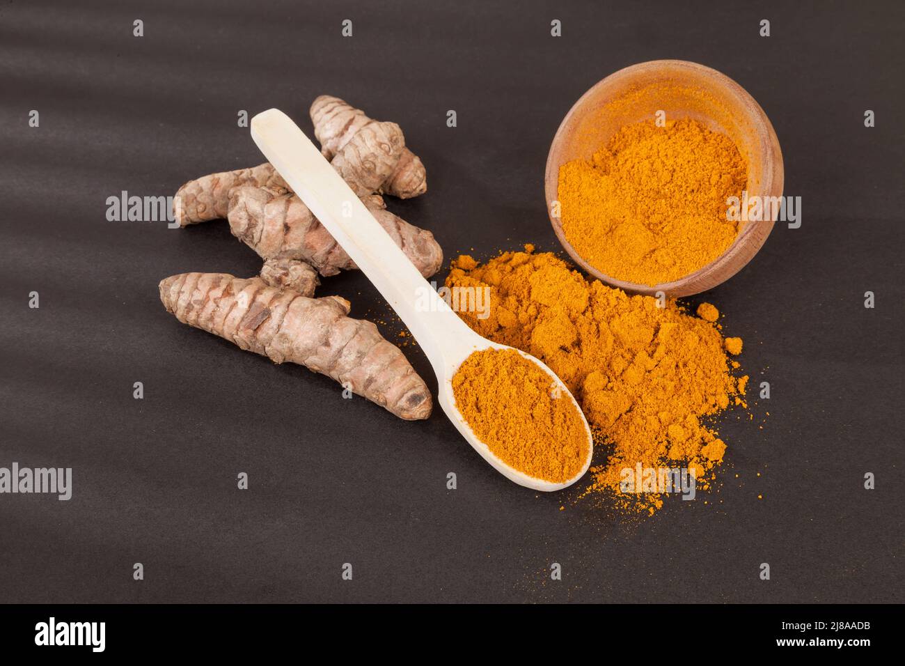 Turmeric - Curcuma longa root and turmeric powder; Photo on dark ...