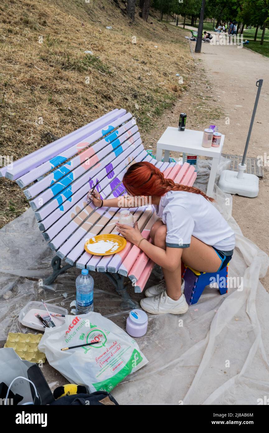 Local young illustrator Carla Loza paints a wooden bench at popular ...