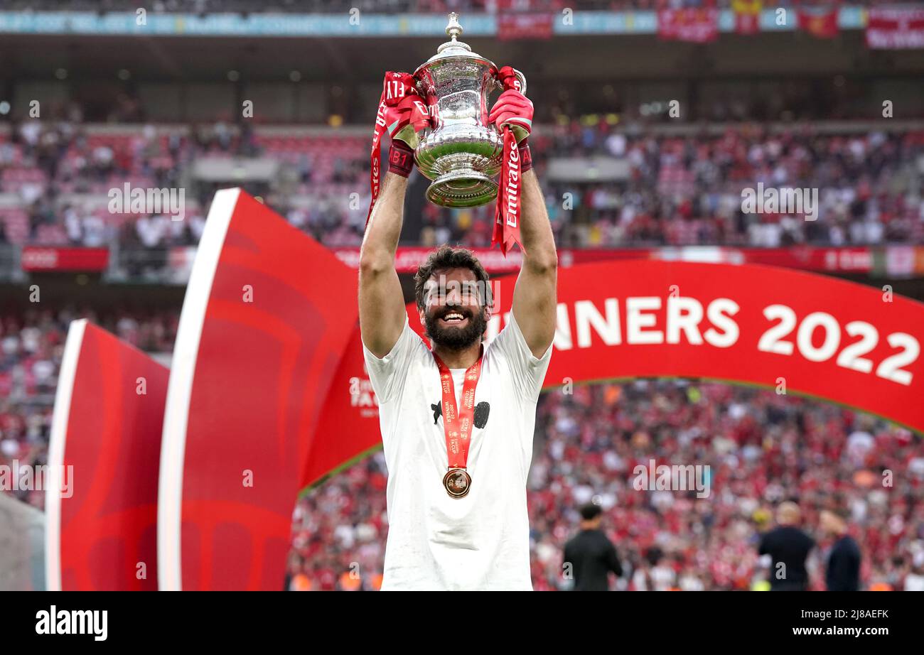 Liverpool goalkeeper Alisson poses with the trophy after the Emirates ...