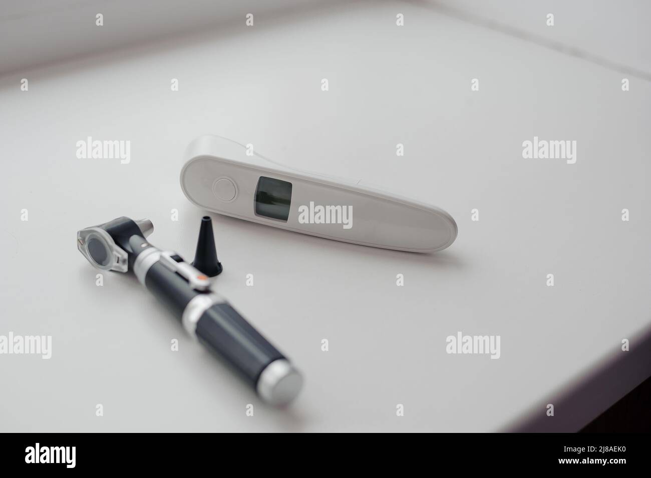 Non-contact thermometer on a white background for measuring body ...