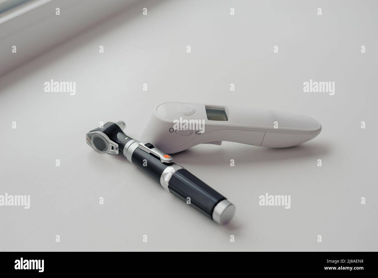 Non-contact thermometer on a white background for measuring body ...