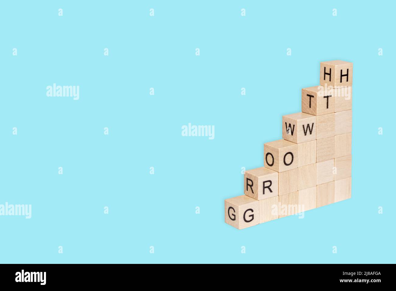 Wooden cubes block which print screen growth wording on blue background ...
